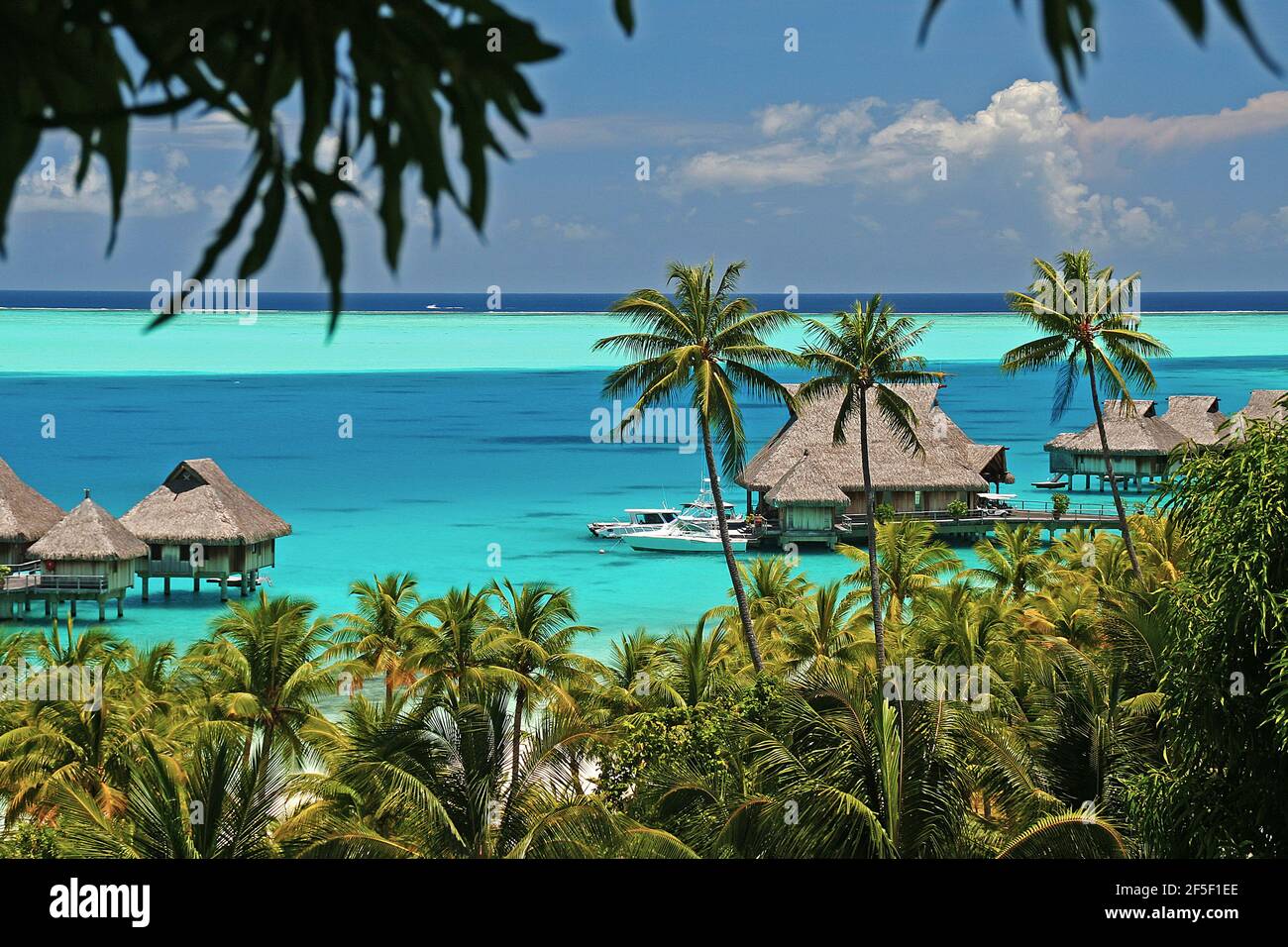 The island is surrounded by a ring or coral reefs, which make the water ...