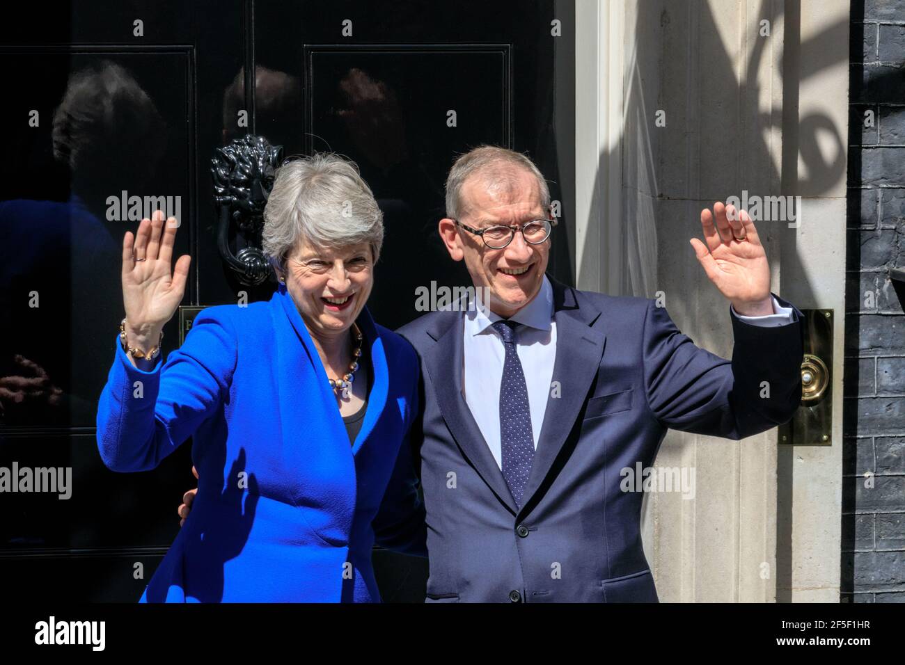 British Prime Minister Theresa May waves, with husband Philip May ...