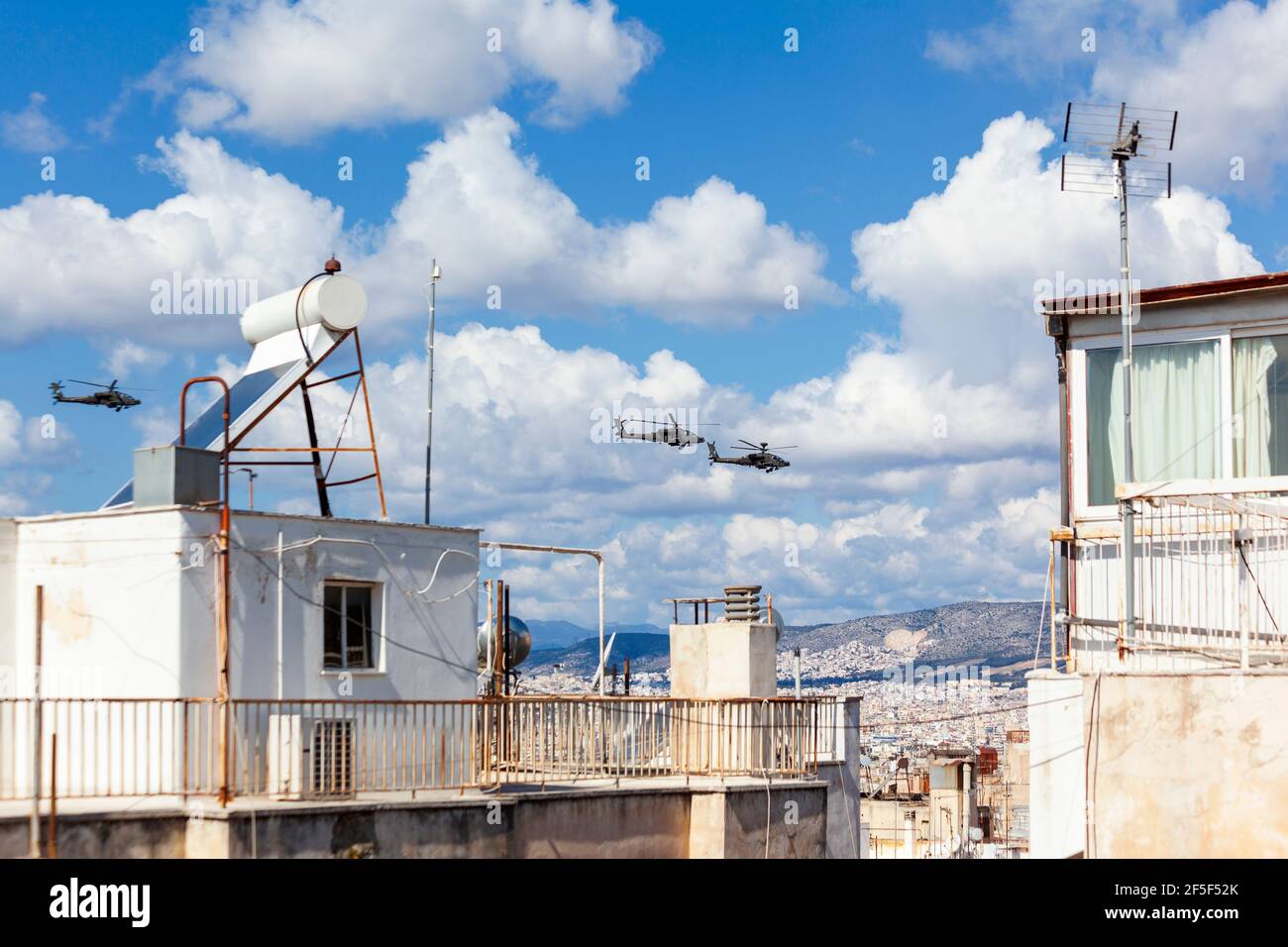 ΑΗ-64 Apache helicopters flying in formation above the city of Athens ...