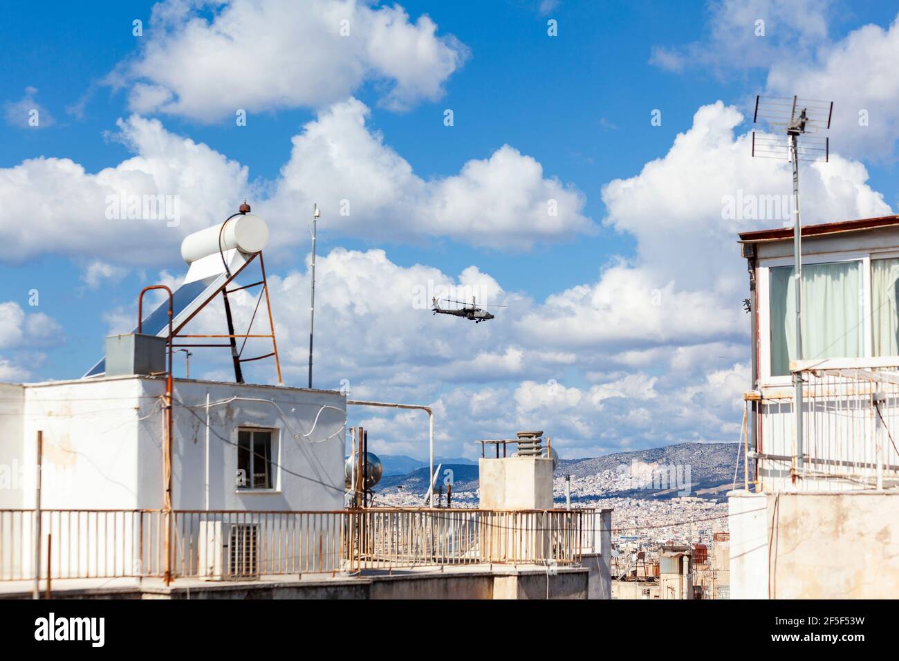 ΑΗ-64 Apache helicopters flying in formation above the city of Athens ...
