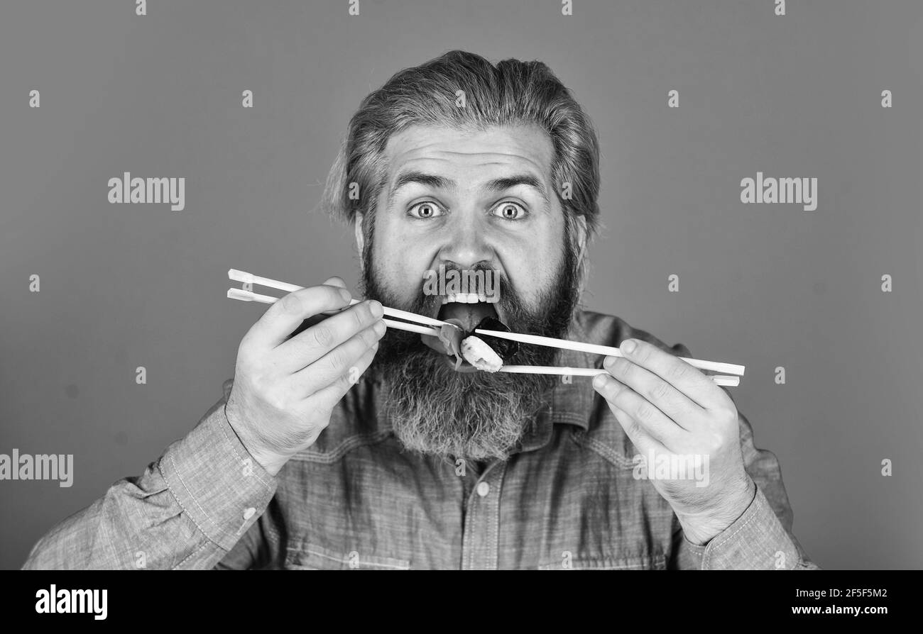 Sushi rolls. Japanese cuisine. Asian meal. Sushi roll. Man eat sushi ...