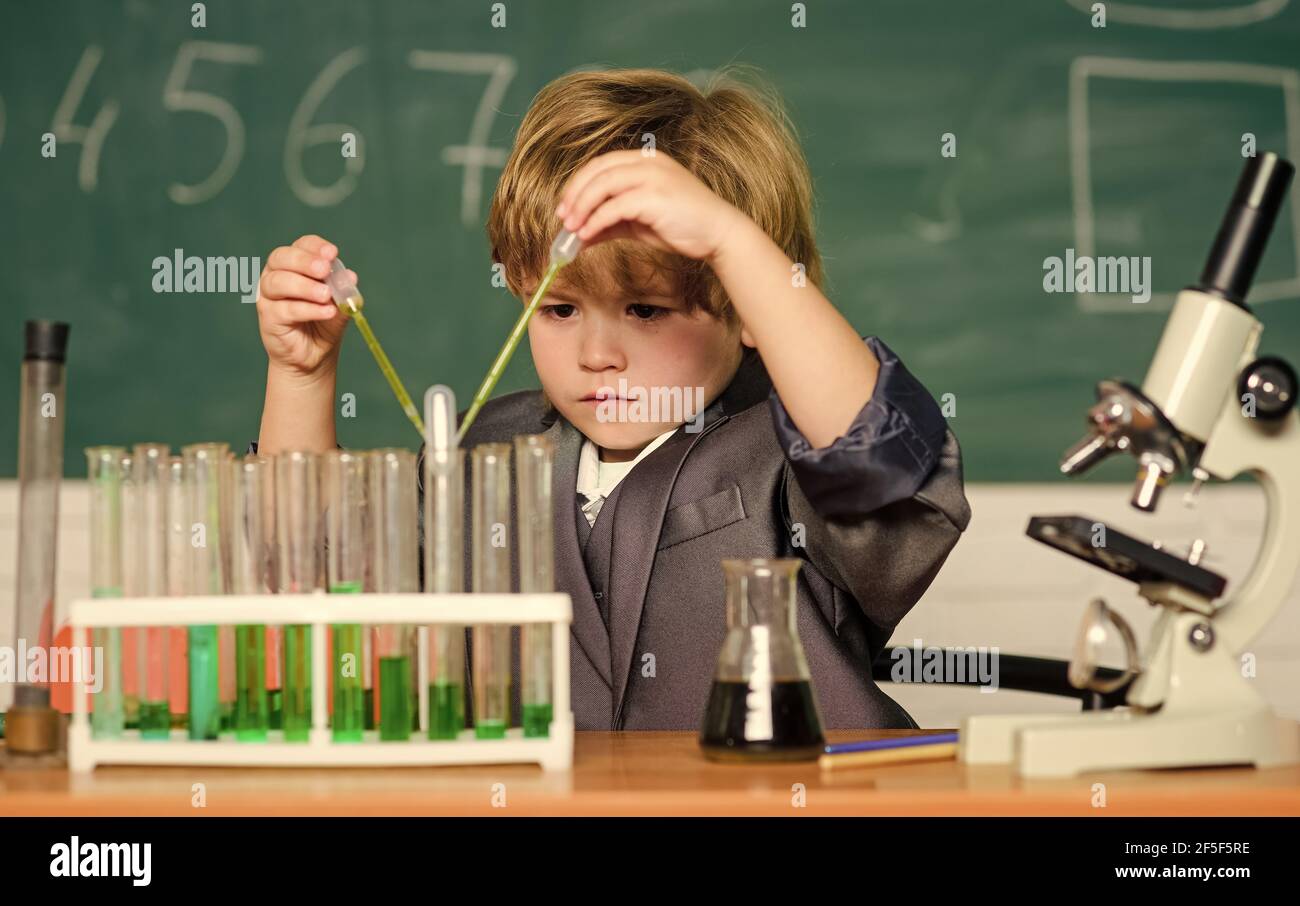 small boy at science camp. microscope at lab. Scientific experiment ...