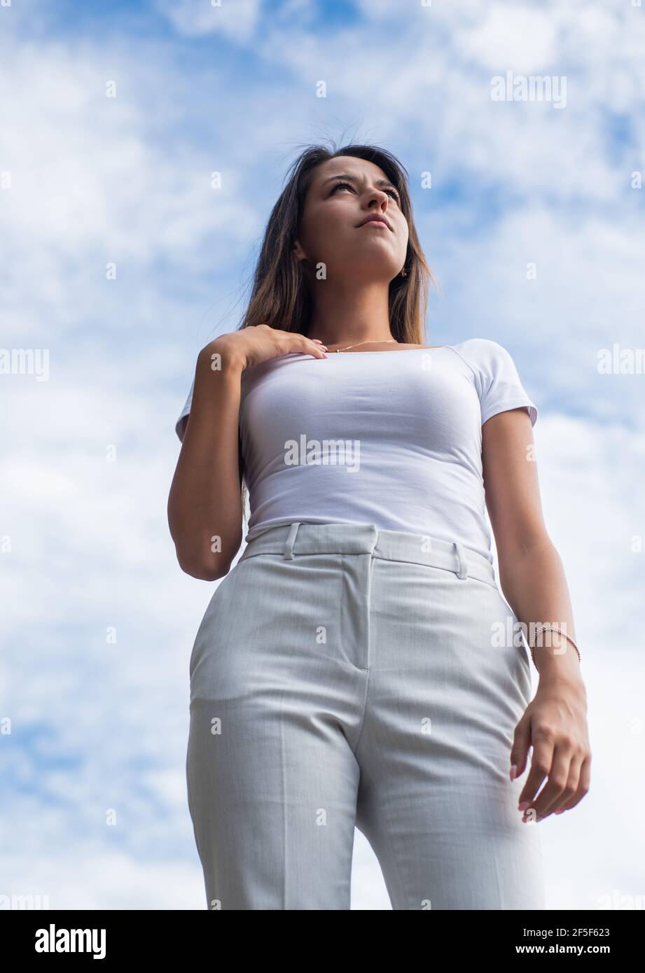 young woman casual style on cloudy sky background, youth Stock Photo ...