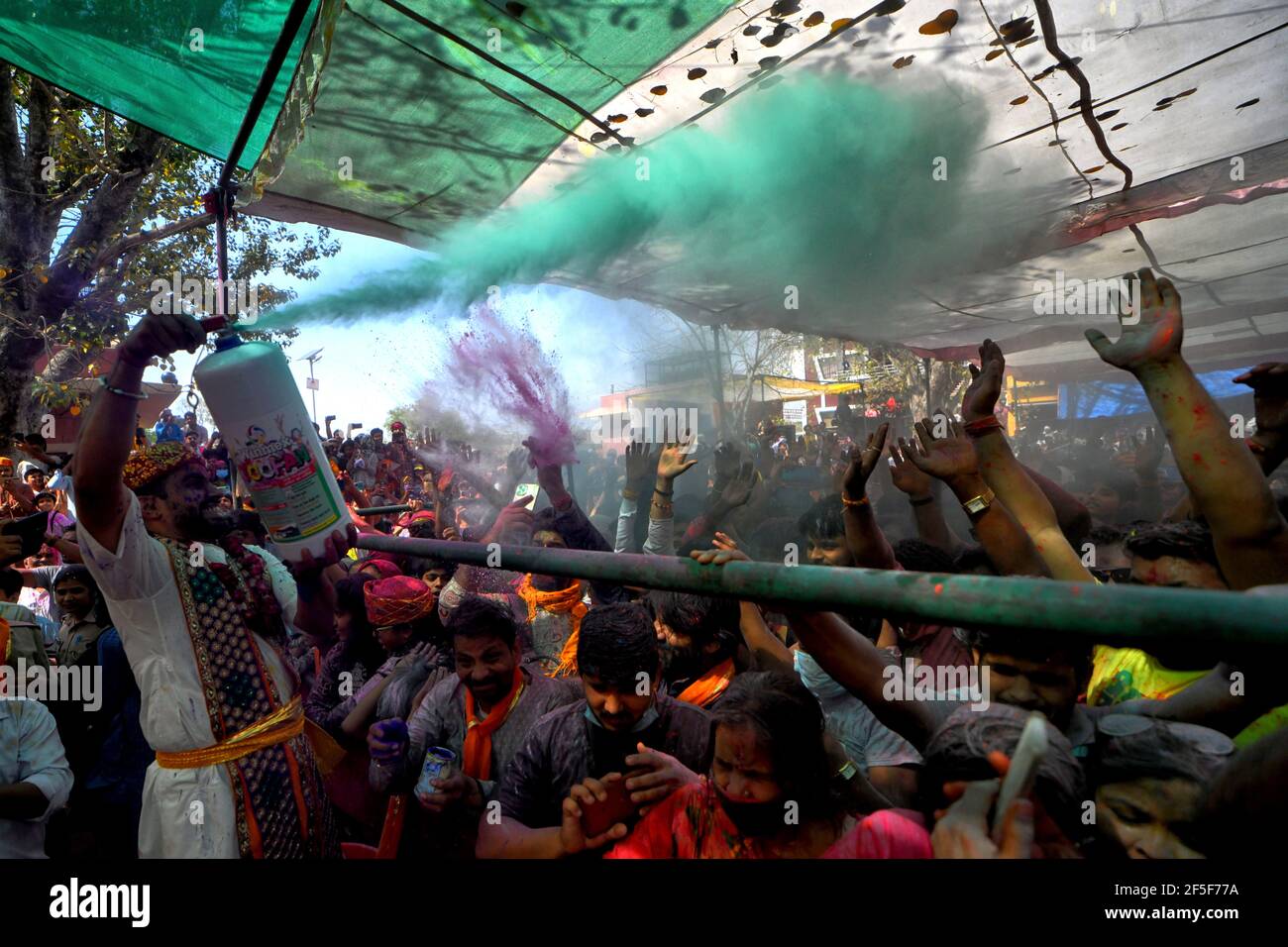 Gokul, India. 26th Mar, 2021. Hindu devotees are seen playing with ...