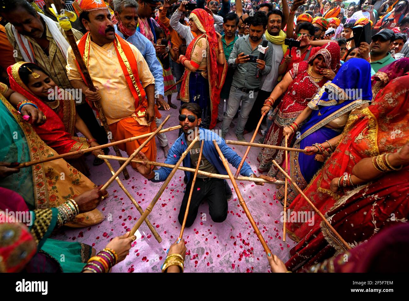 Gokul, India. 26th Mar, 2021. Hindu devotees are seen playing with ...