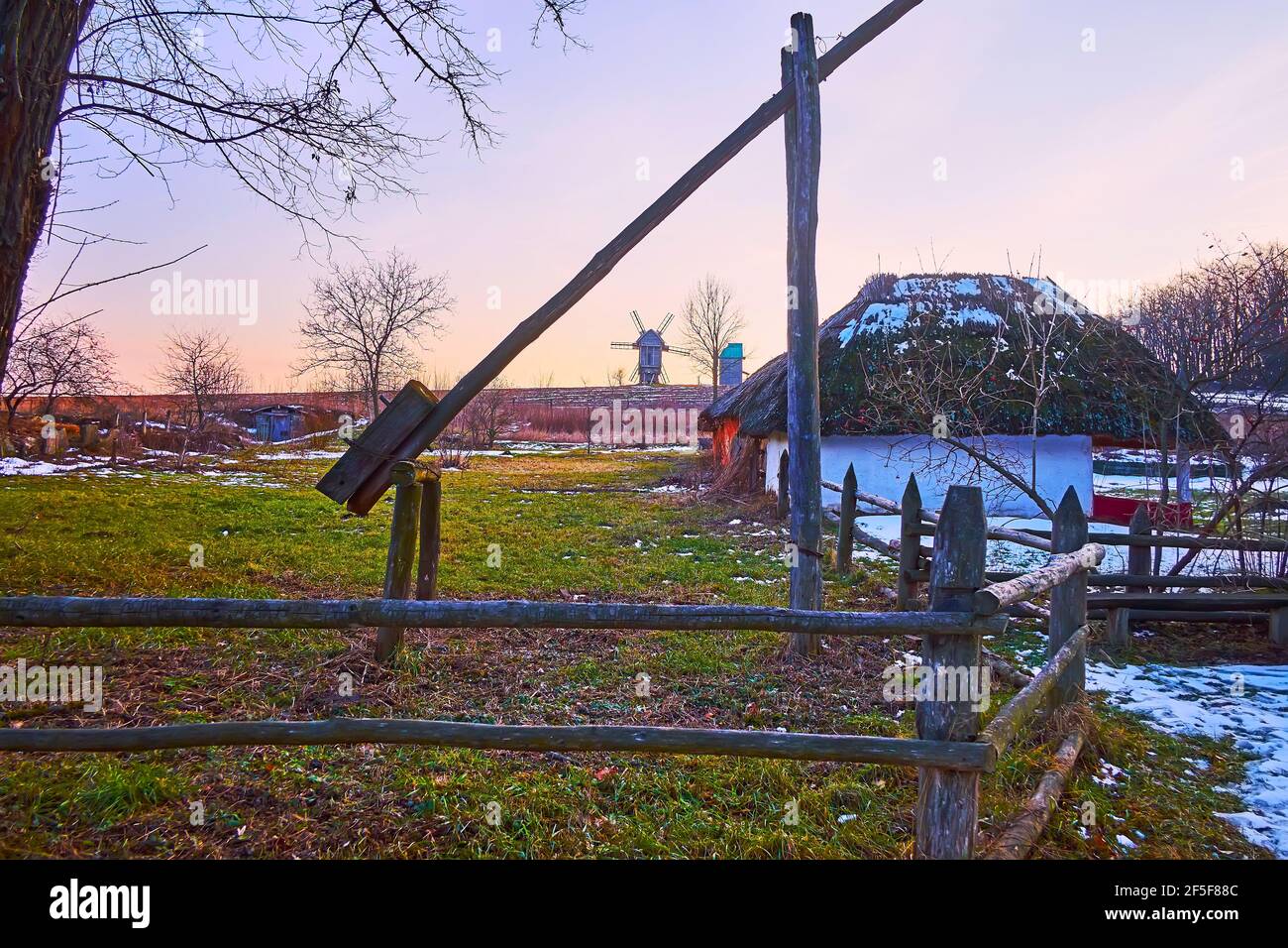 Traditional farmstead of Podillya Region with timber fence, crane well ...