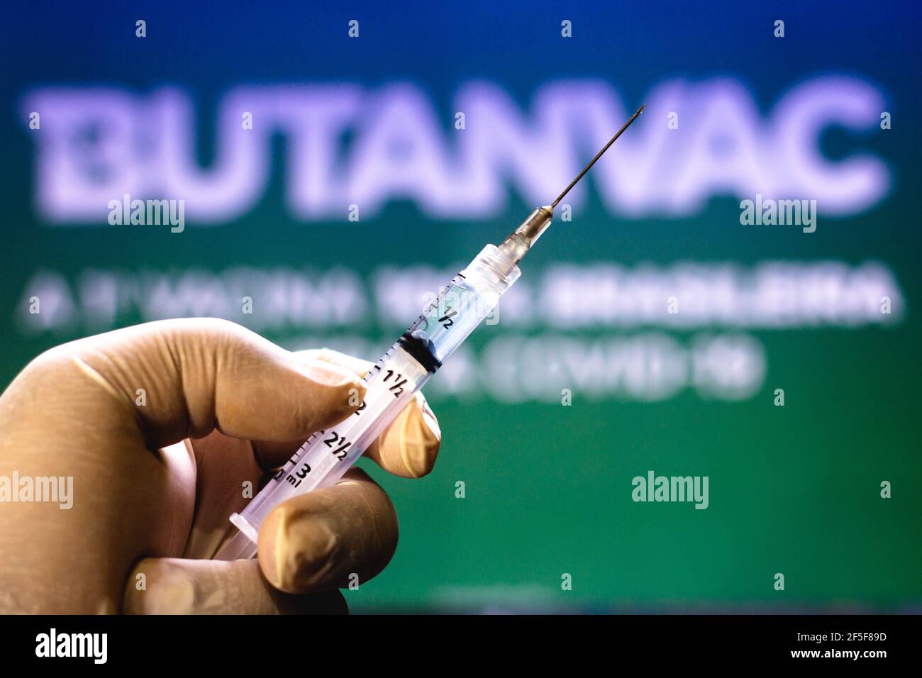 In this photo illustration a medical syringe is seen with Butanvac logo ...