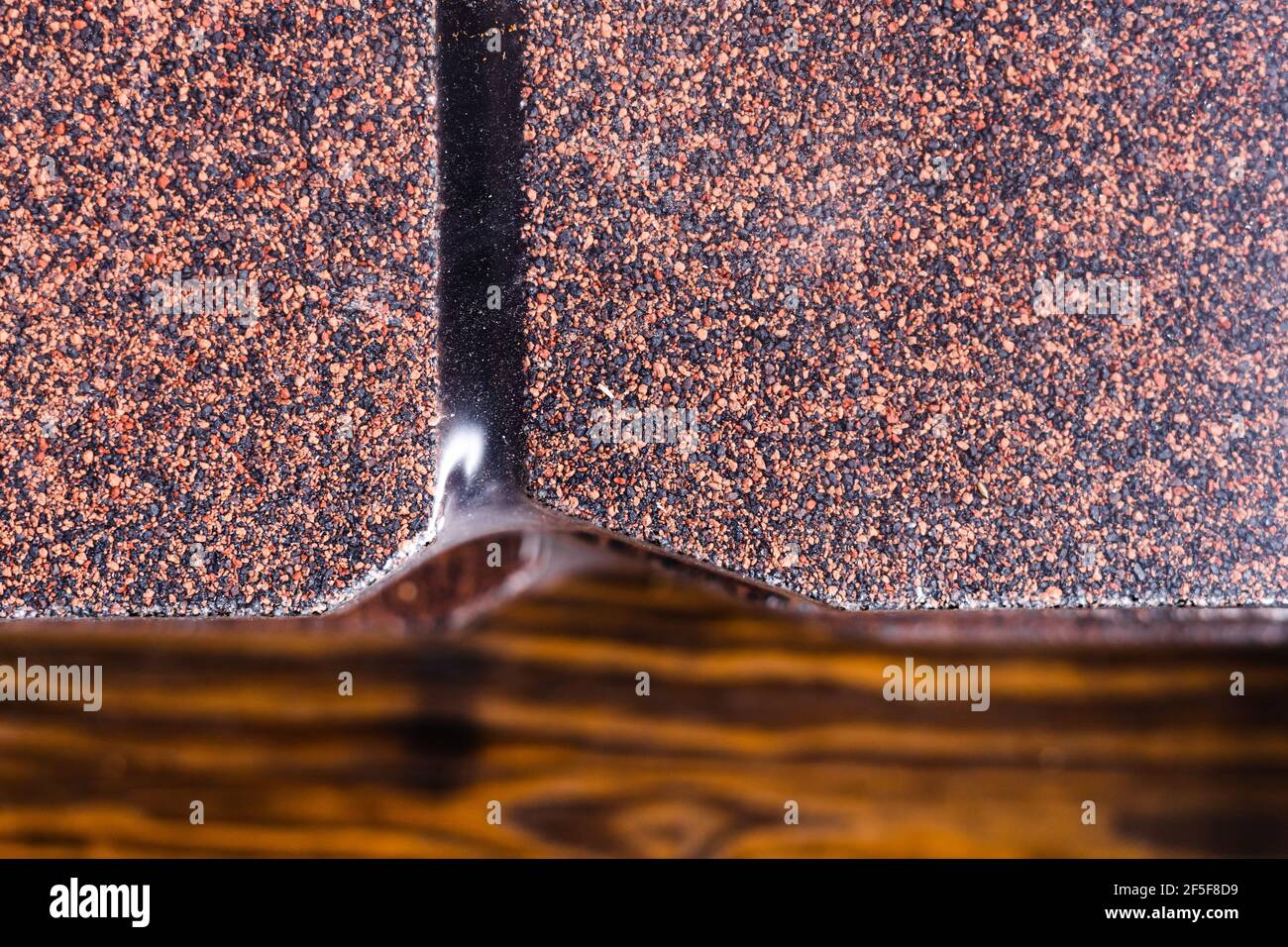 Brown bituminous shingles packed in their original packaging close-up ...