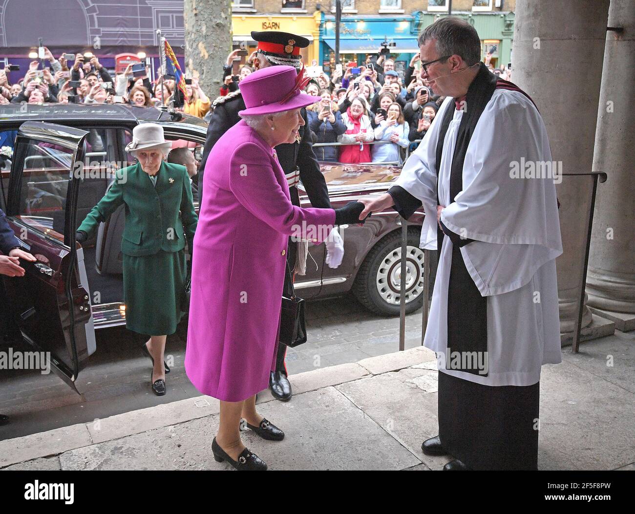 Queen Elizabeth II meets the Rev Simon Harvey, vicar of St Mary's, as ...