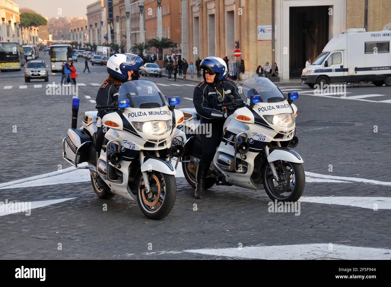 Two women in municipal police uniforms patrol the streets of Rome ...