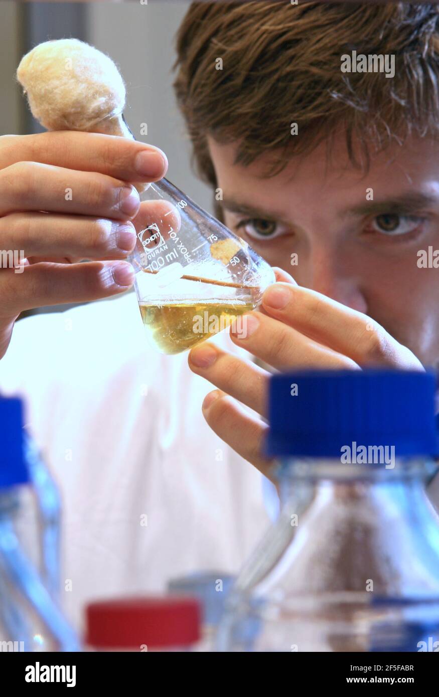 A researcher,student of physics,chemistry doing a science experiment in ...