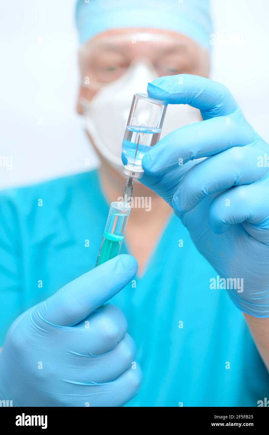 A medical professional is holding a syringe Stock Photo - Alamy