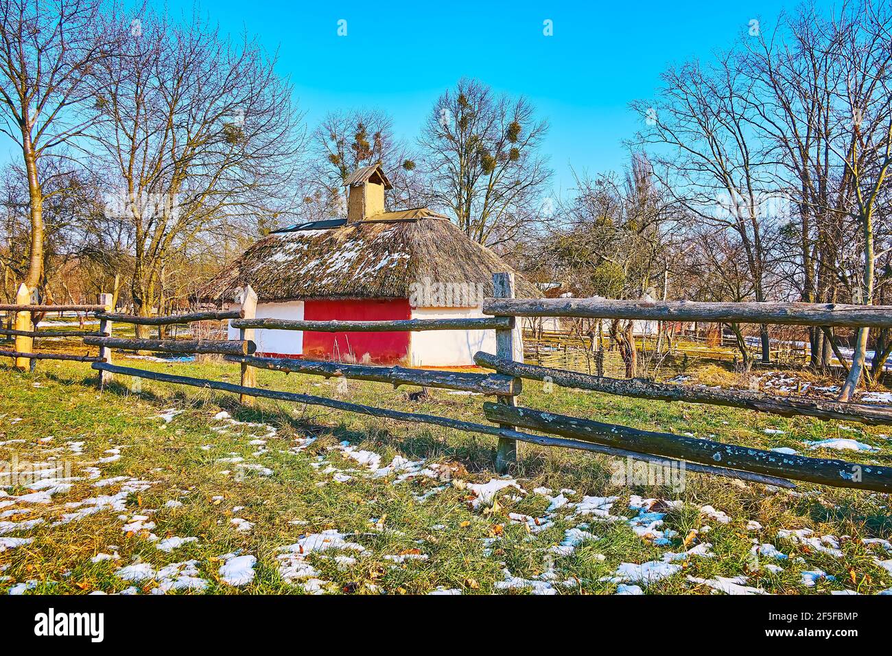 The view of the old Ukrainian farmstead behind the timber fence ...