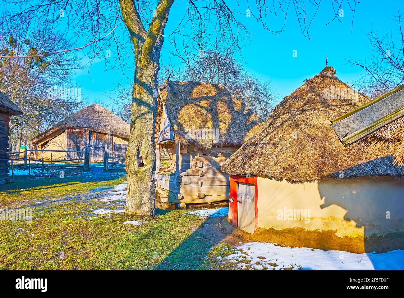The timber playpen and clay buildings of barns and storages on the ...