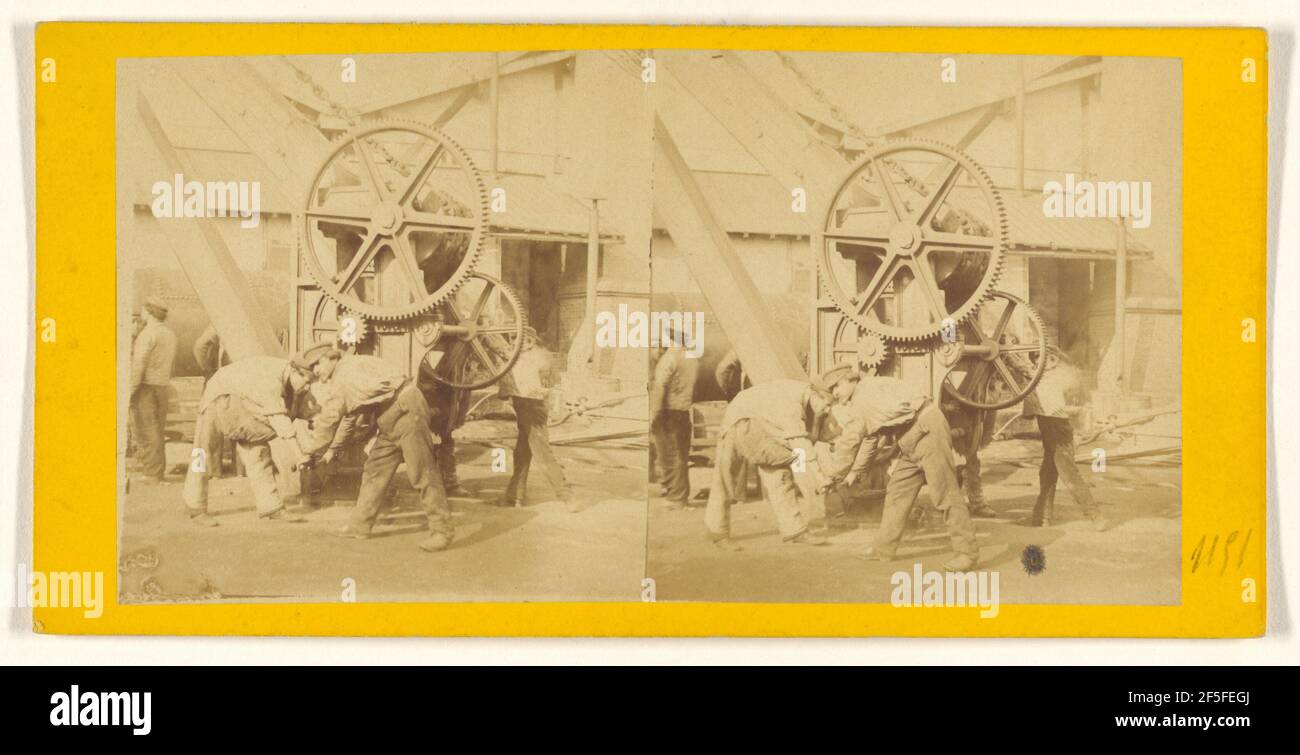 Man cranking a large machine. Unknown Stock Photo - Alamy