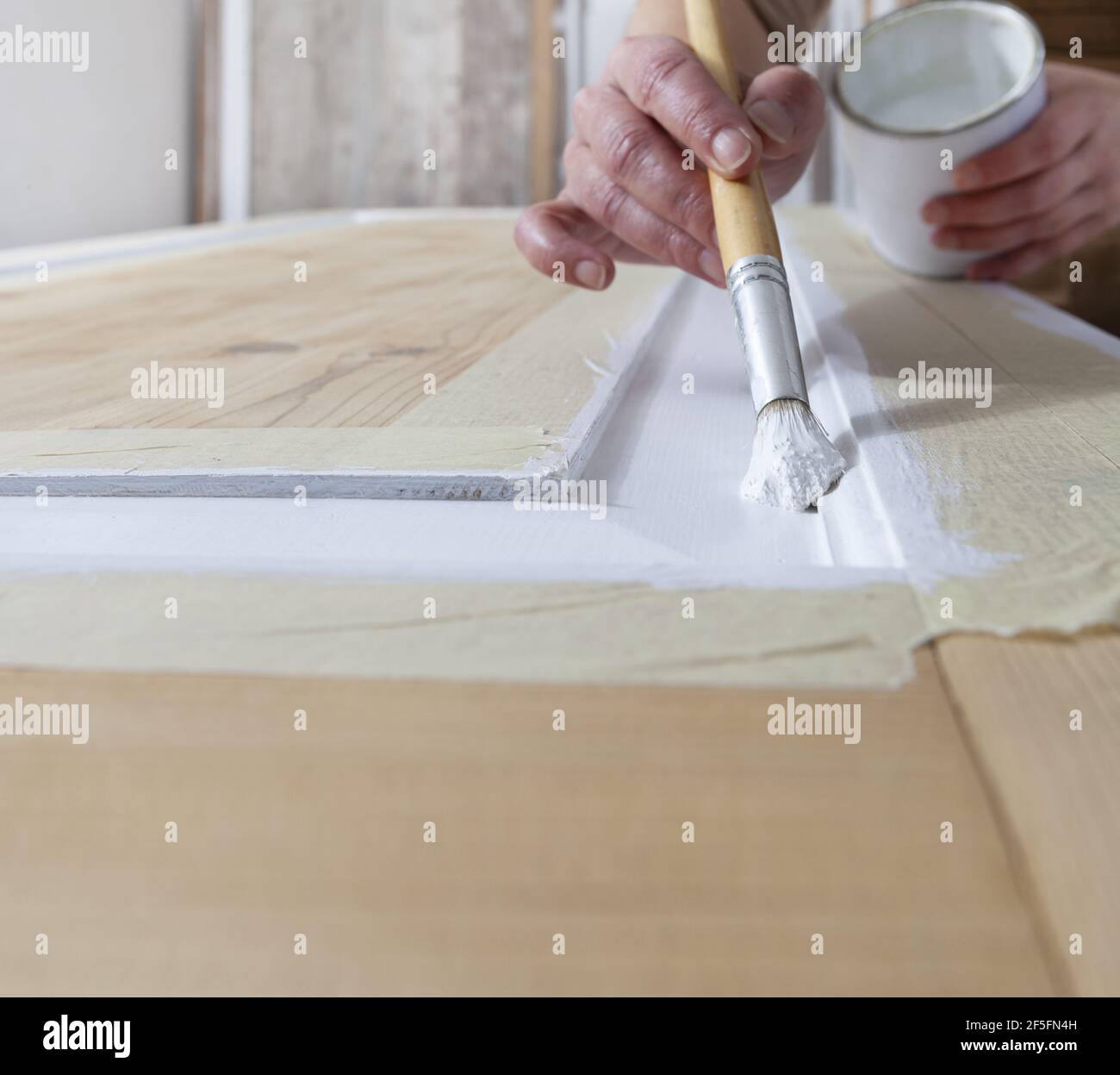 wood crafts, close up hands woman artisan carpenter painting with brush ...