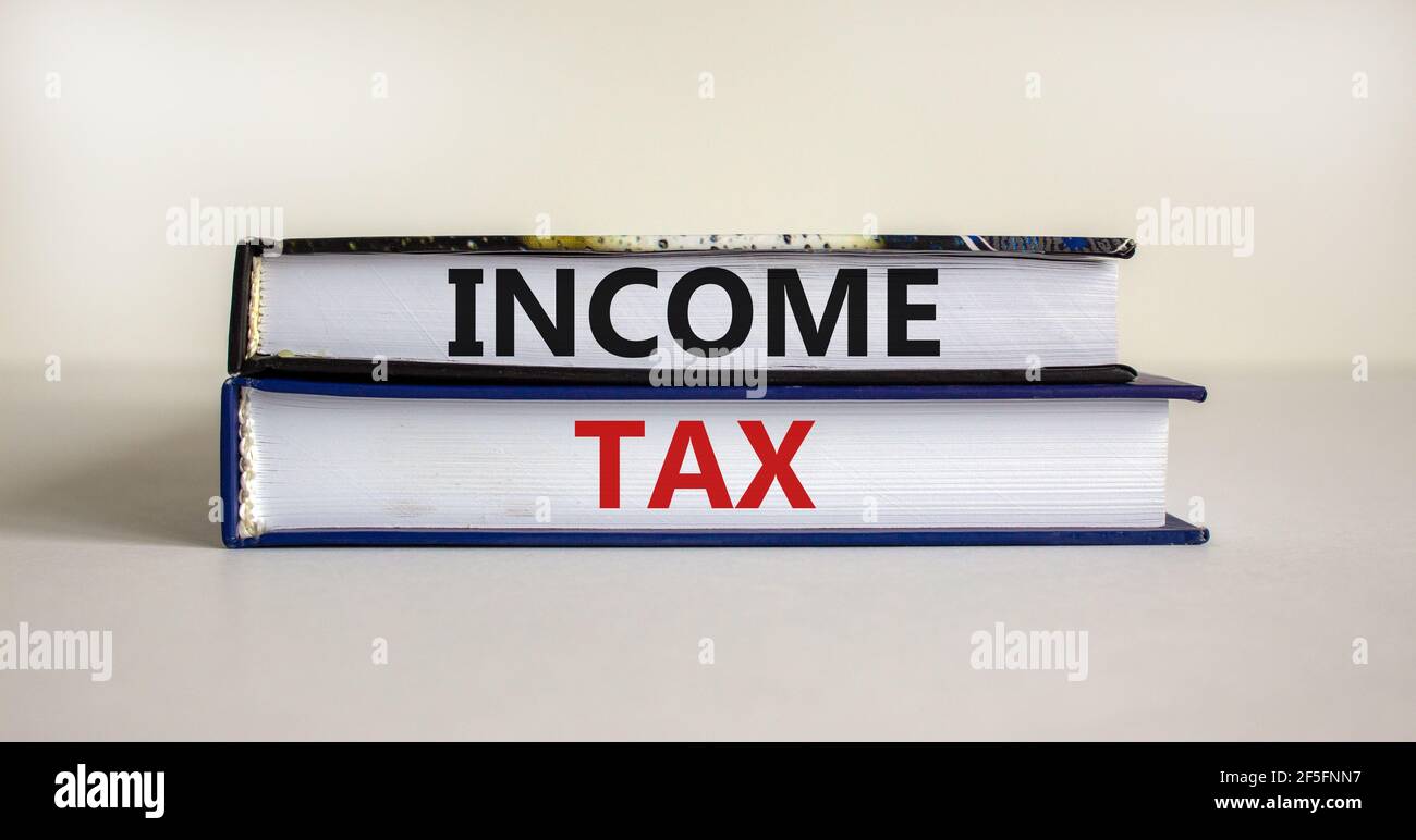 Income tax symbol. Concept words 'income tax' on books on a beautiful ...
