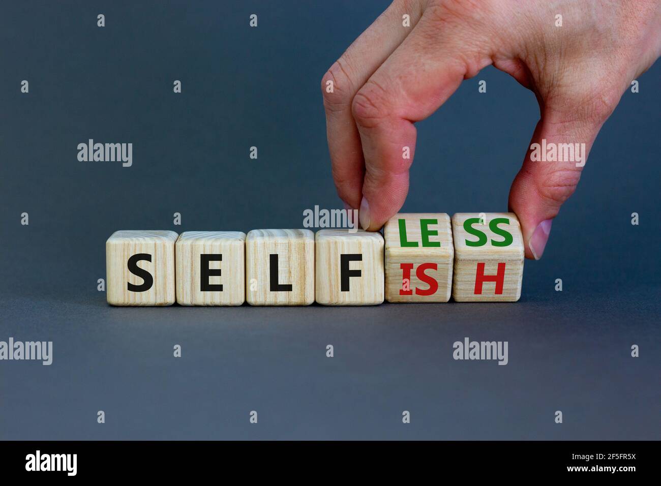 Selfish or selfless symbol. Businessman turns cubes and changes the ...