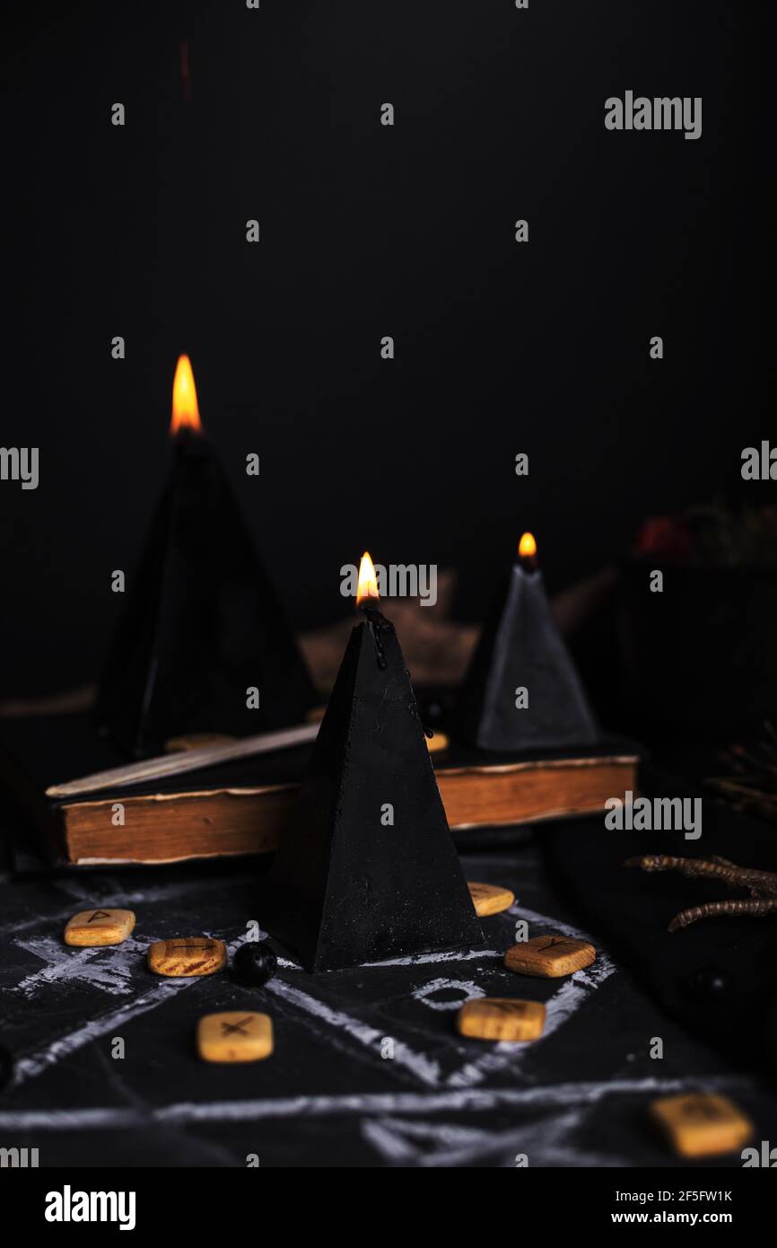 Still life with burning candles and pentagram circle background. Black ...