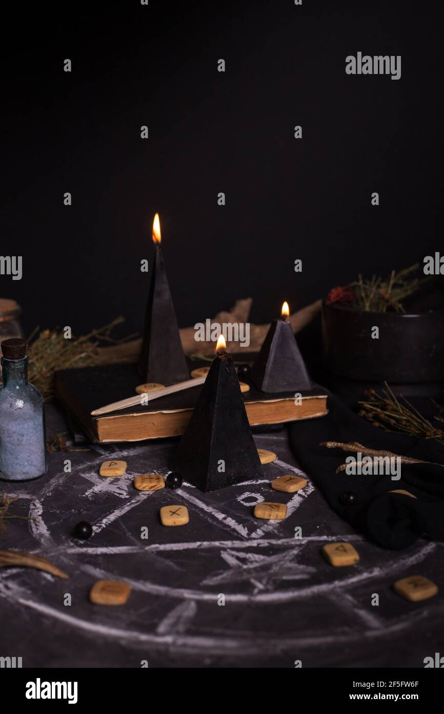 Still life with burning candles and pentagram circle background. Black ...