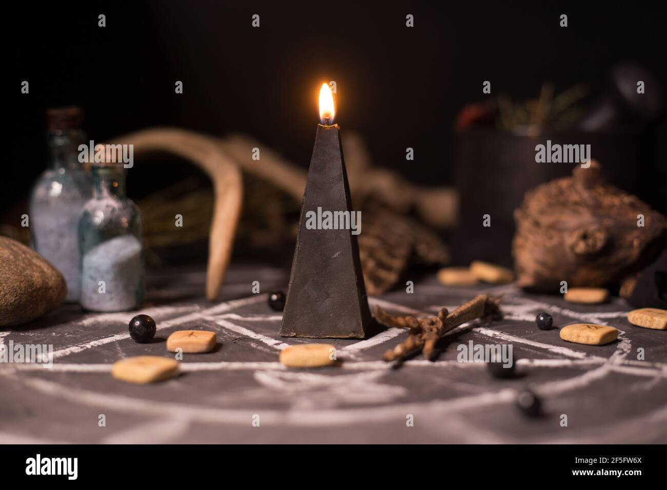 Still life with burning candles and pentagram circle background. Black ...