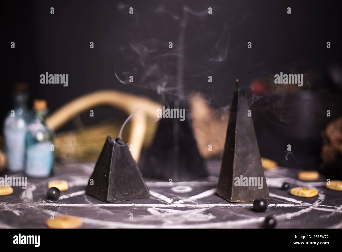 Still life with burning candles and pentagram circle background. Black ...