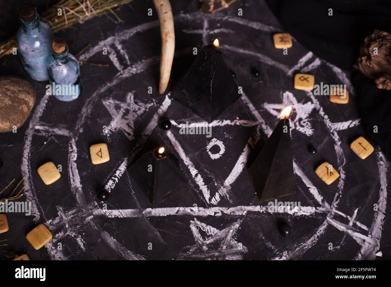 Still life with burning candles and pentagram circle background. Black ...
