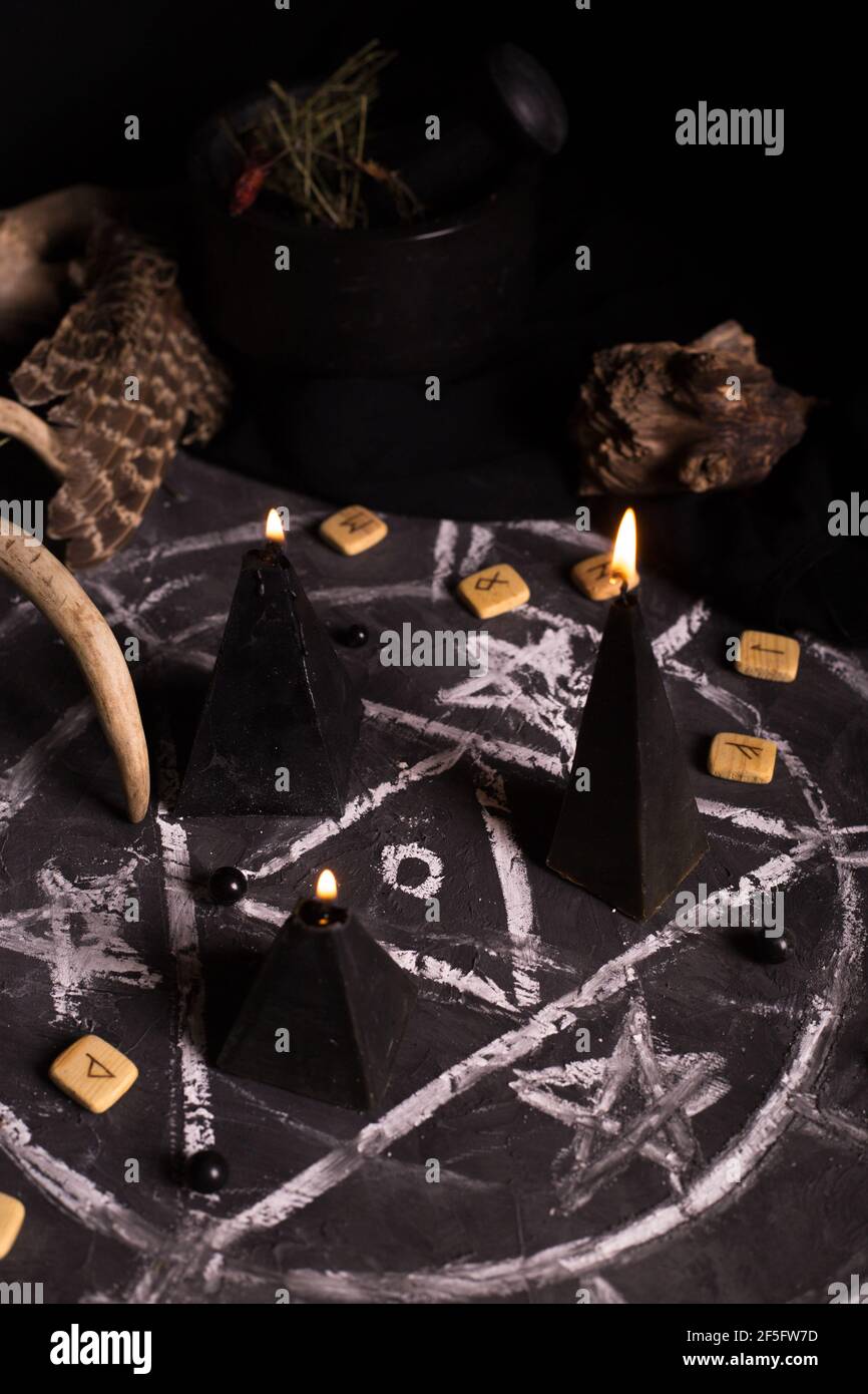 Still life with burning candles and pentagram circle background. Black ...