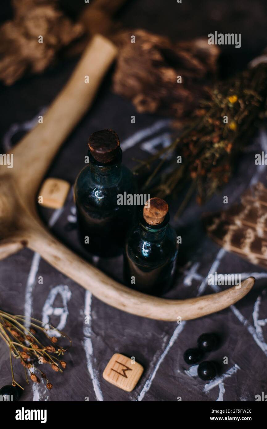 Magic potion bottle. Modern witchcraft concept with potions, herbs and ...