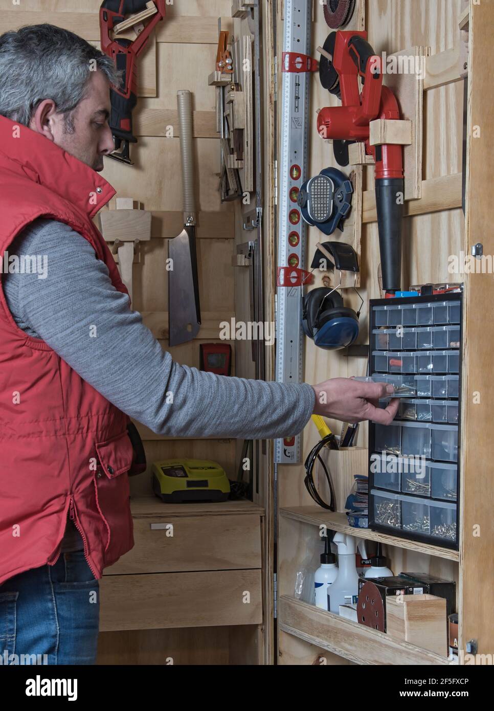 Do-it-yourself at home, man takes carpentry tool Stock Photo - Alamy