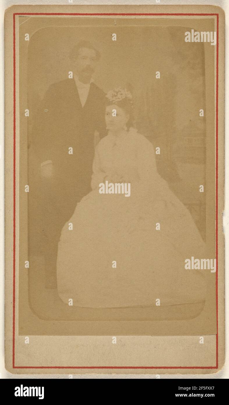 Unidentified couple: man with moustache standing, woman seated. Charles ...