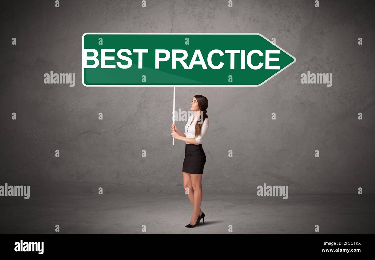 Young business person in casual holding road sign Stock Photo - Alamy