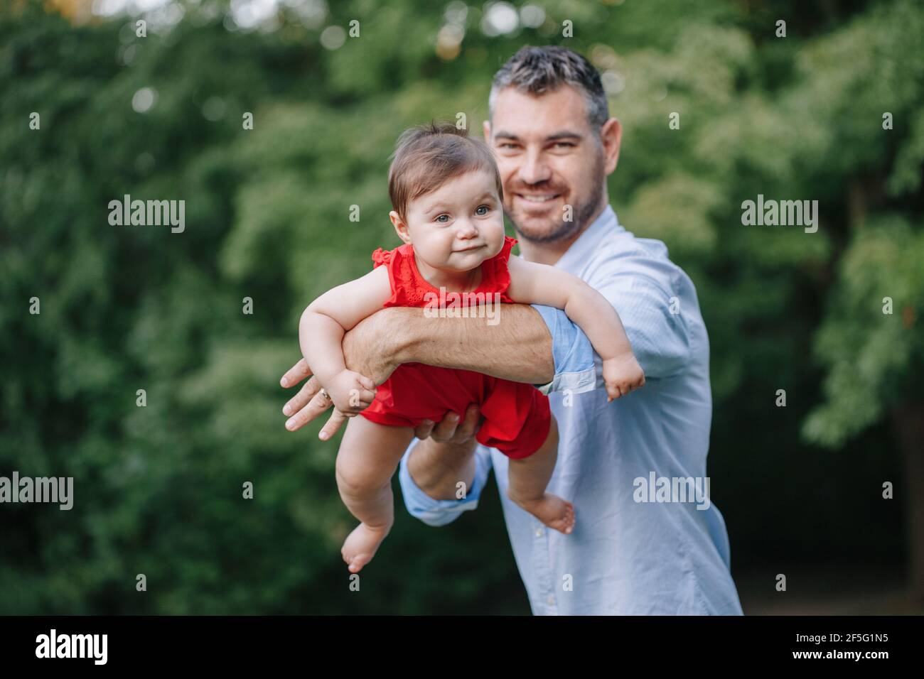 Fathers Day. Middle age Caucasian proud father dad hugging playing with ...