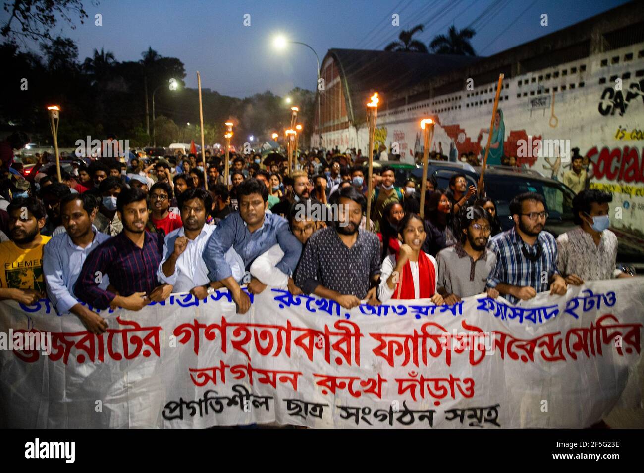 (3/25/2021) Protesters take part in a torch procession against the ...
