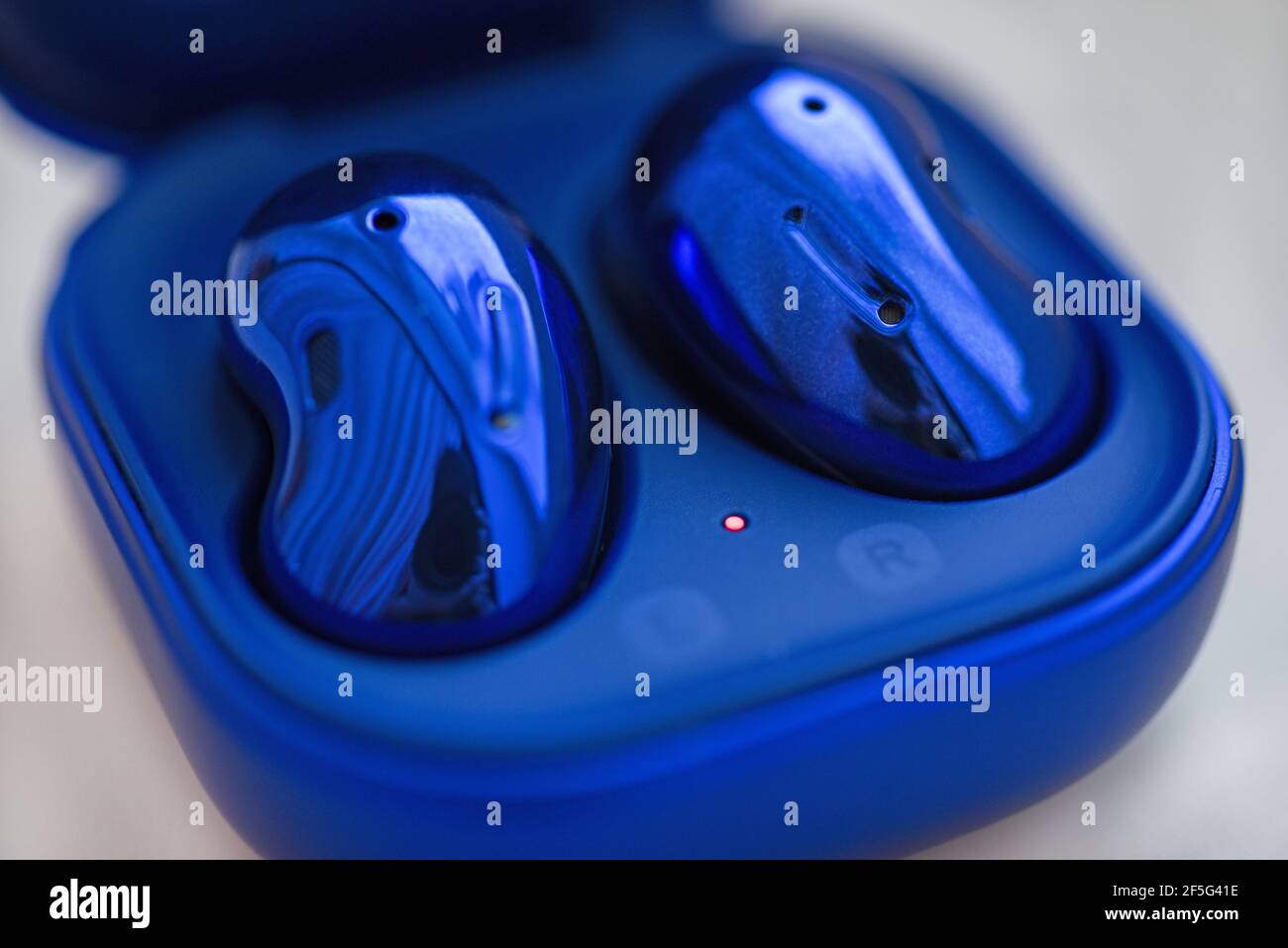 Blue wireless earbuds earbuds in a case on a white background Stock ...