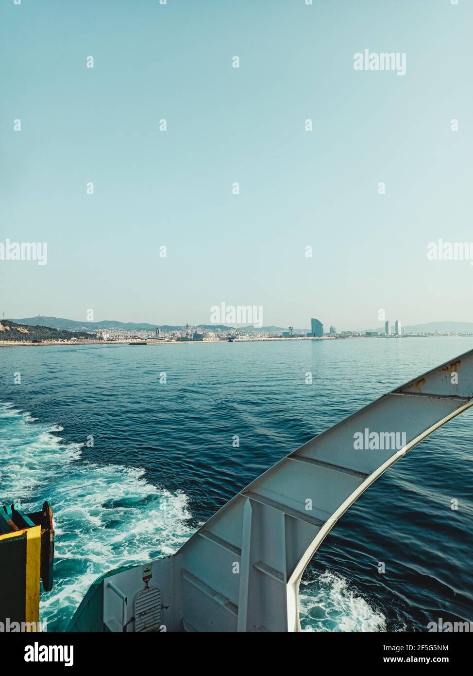 Wave wake from sailing ship with Port and Ropeway of Barcelona, Spain ...