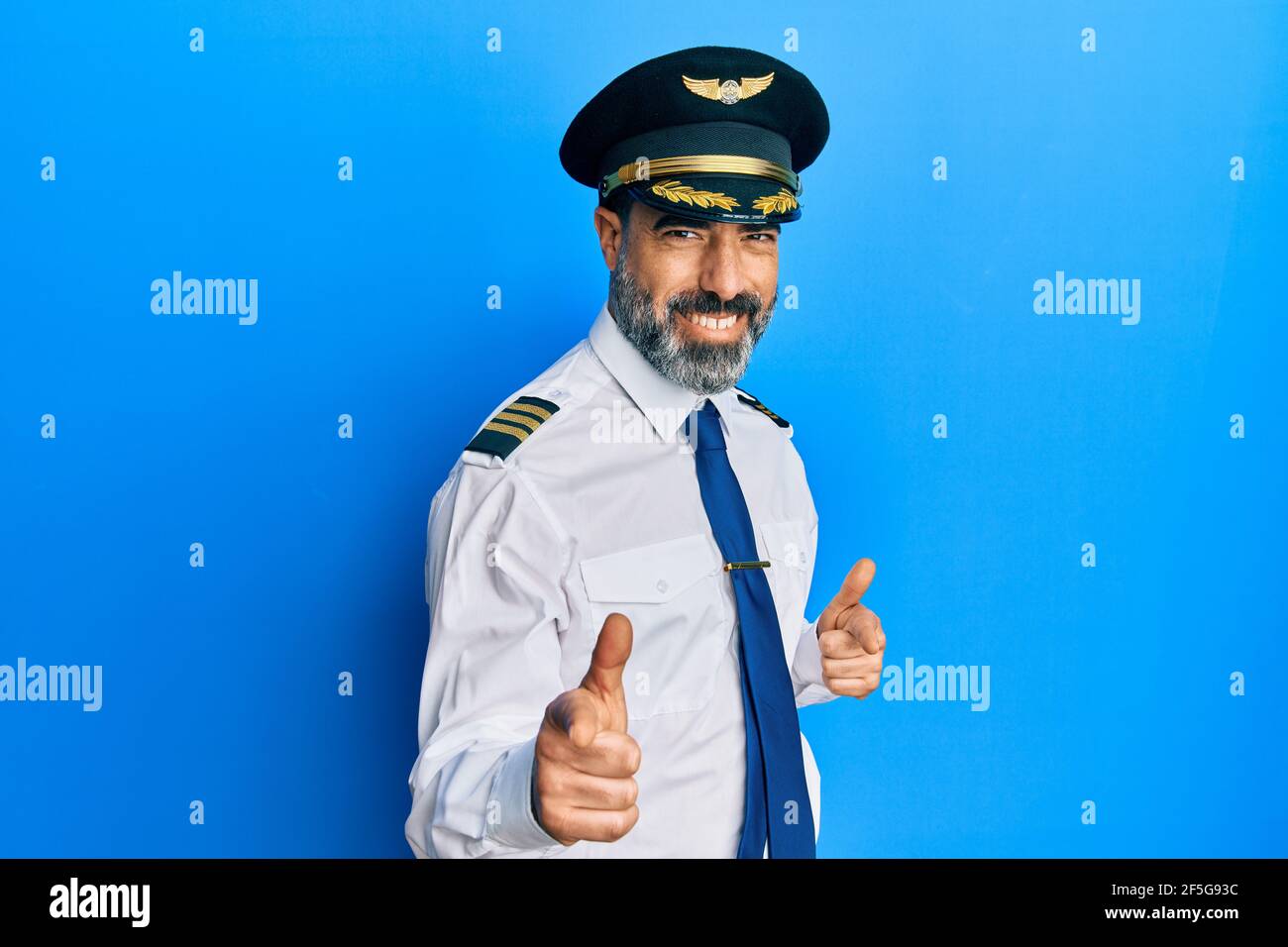 Middle age man with beard and grey hair wearing airplane pilot uniform ...