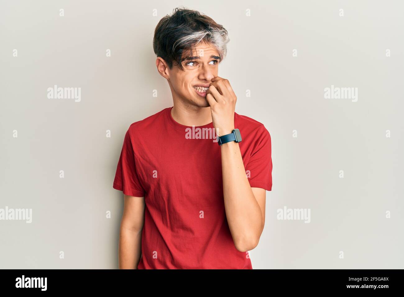 Young hispanic man wearing casual clothes looking stressed and nervous ...