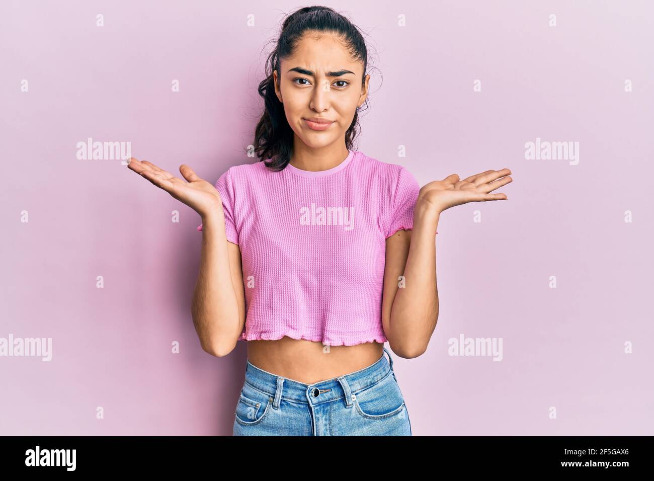 Hispanic teenager girl with dental braces wearing casual clothes ...