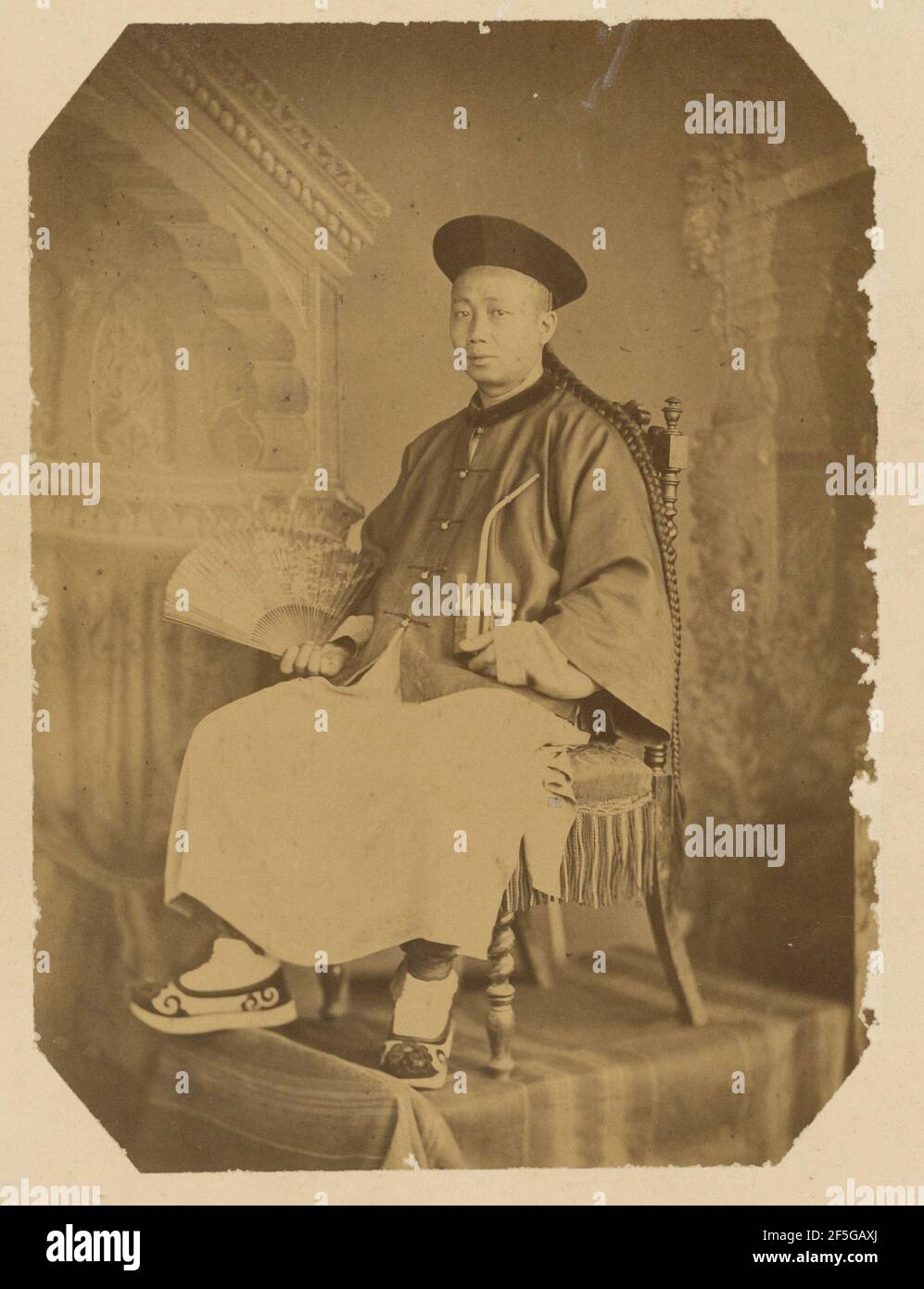Seated Chinese Coolie wirh Braided Queue, Holding a Fan and a Pipe ...