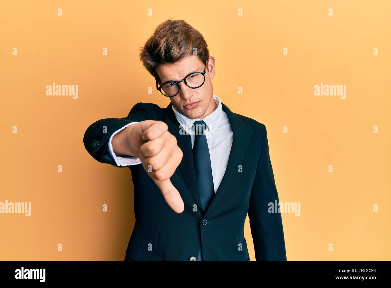Handsome caucasian man wearing business suit and tie looking unhappy ...