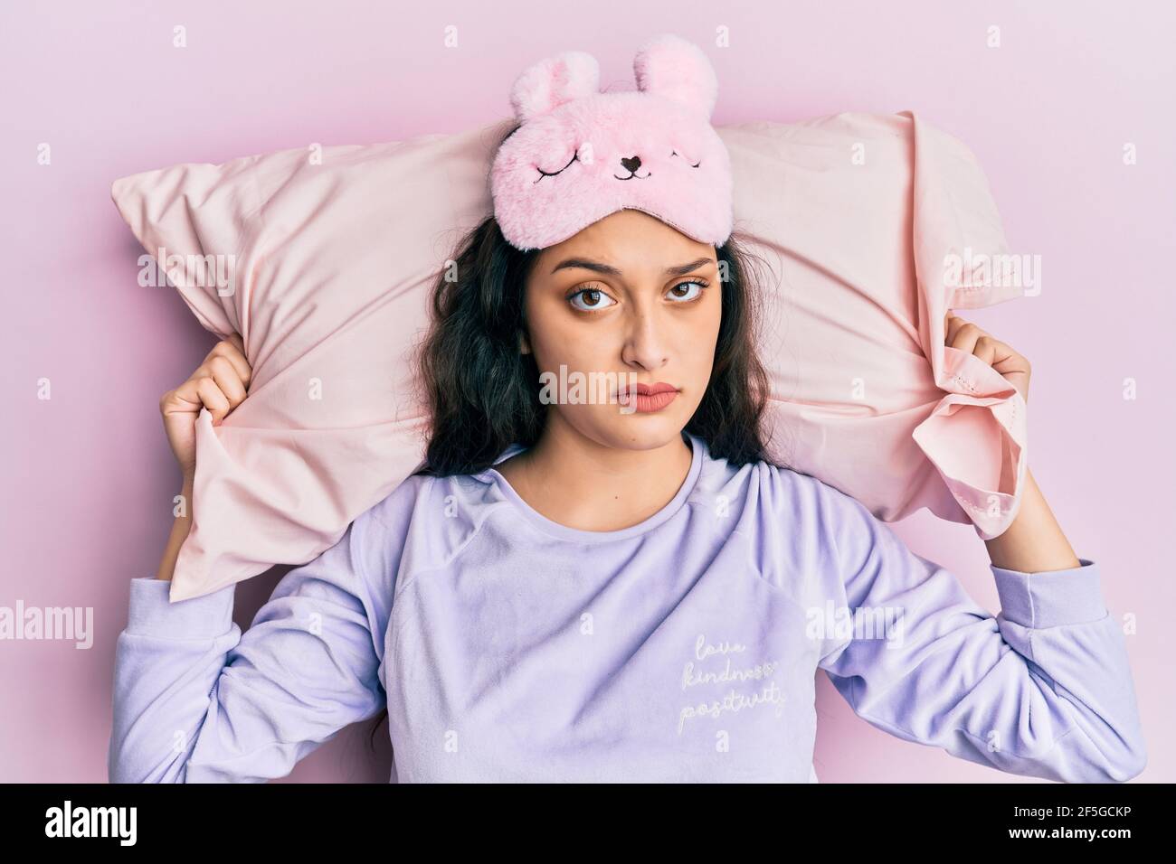 Beautiful middle eastern woman wearing sleep mask and pajama sleeping ...