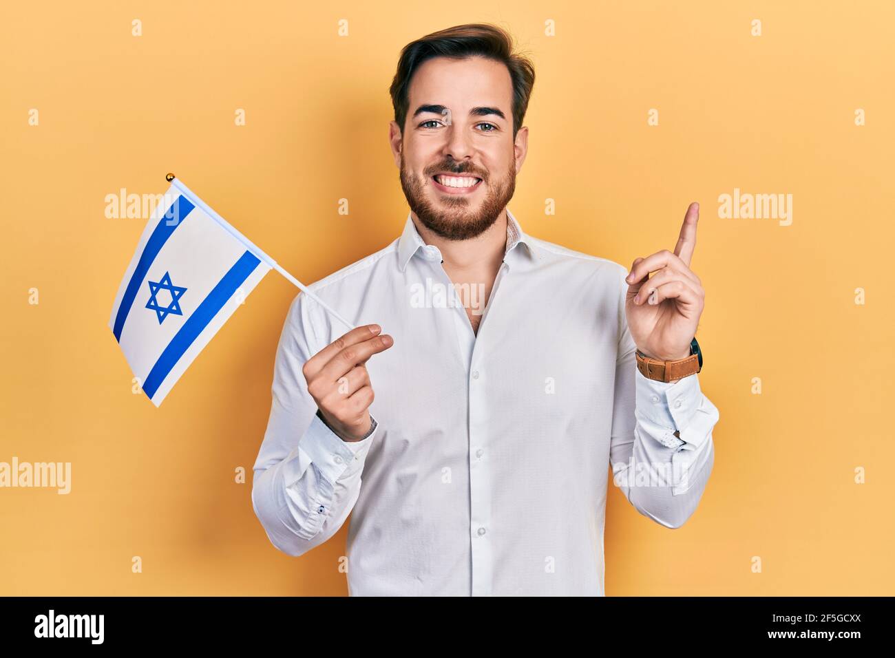 Handsome caucasian man with beard holding israel flag smiling happy ...