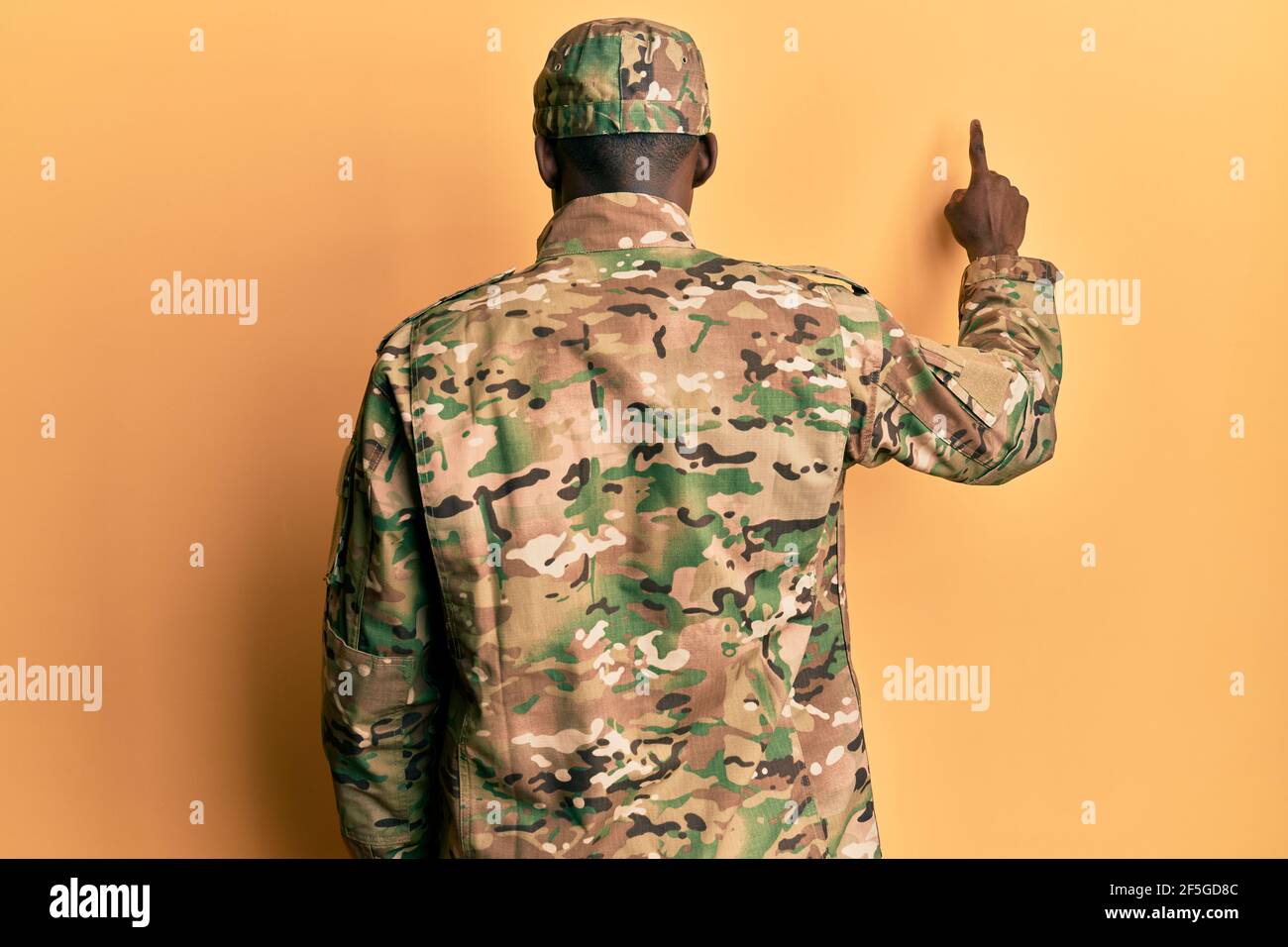 Young african american man wearing army uniform posing backwards ...