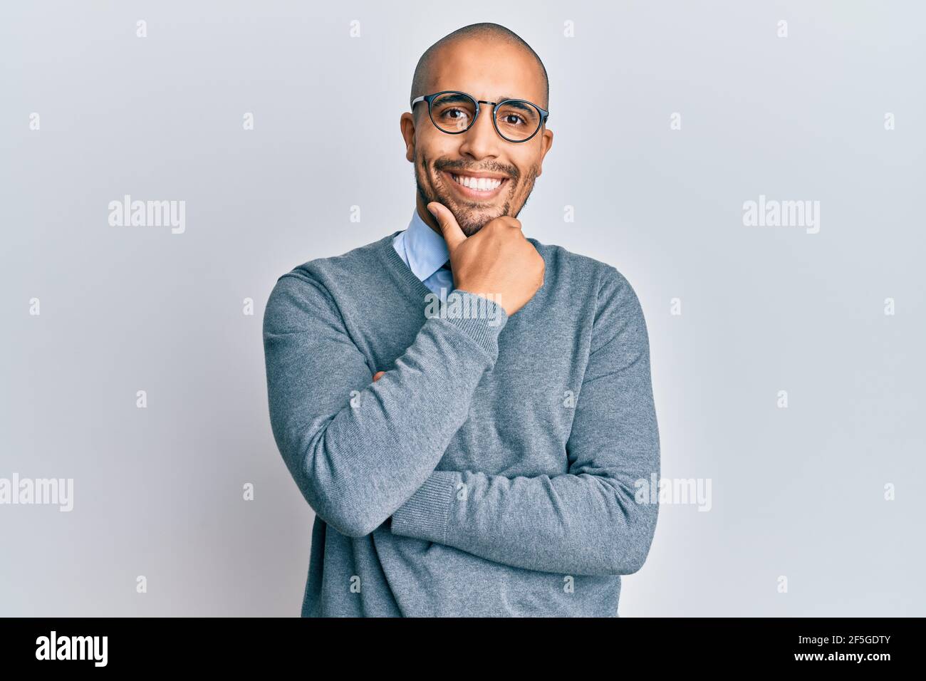 Hispanic adult man wearing glasses and business style looking confident ...