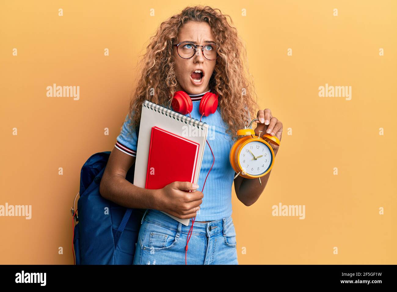 Beautiful caucasian teenager girl wearing student backpack and holding ...