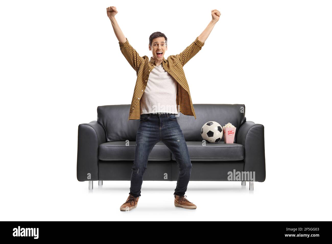 Full length portrait of a young man cheering and watching football ...