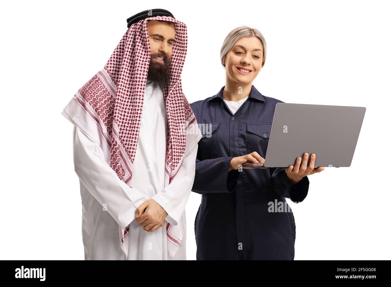 Female worker and a saudi arab man looking at a laptop computer ...