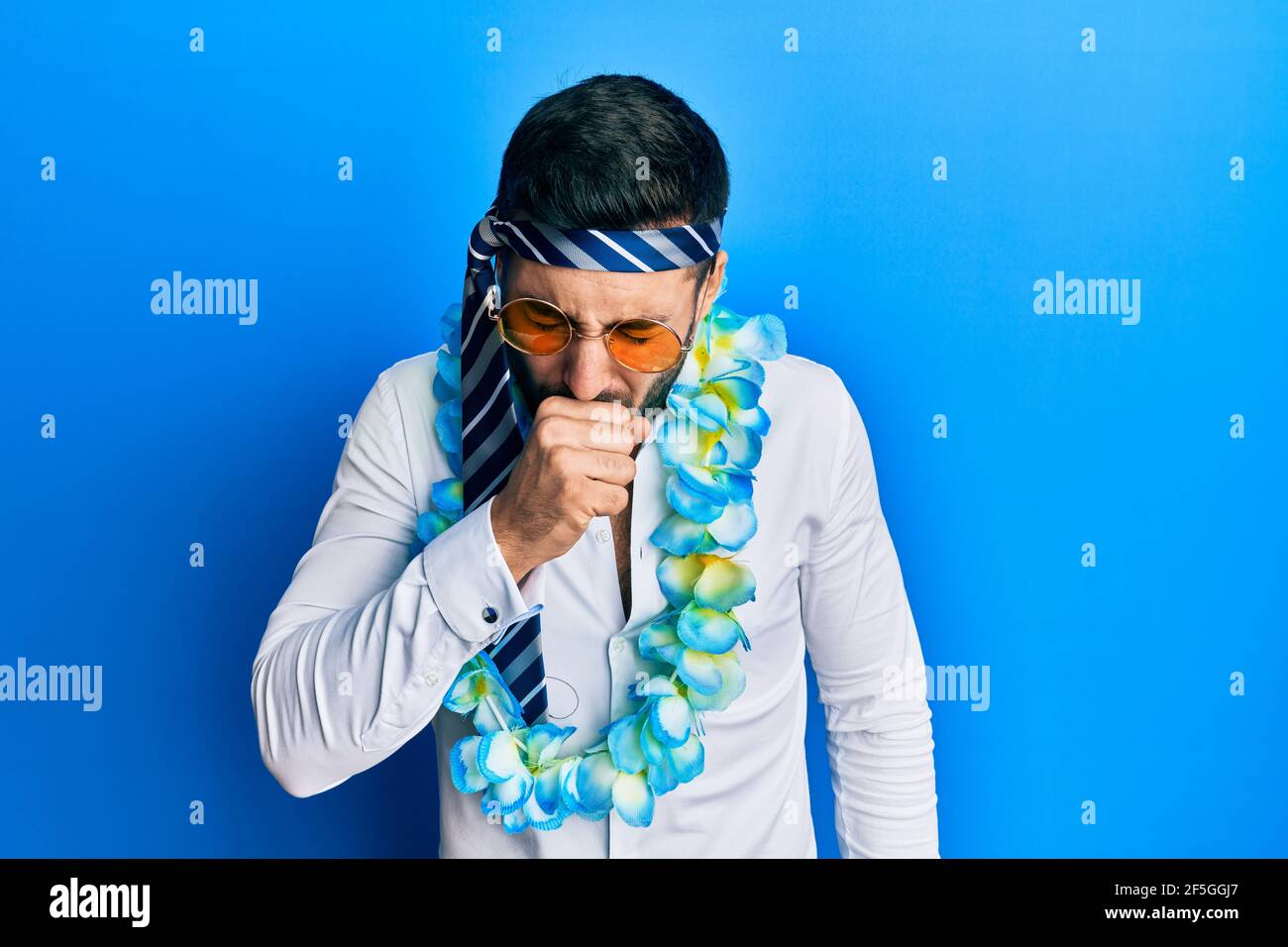 Young hispanic businessman wearing party funny style with tie on head ...