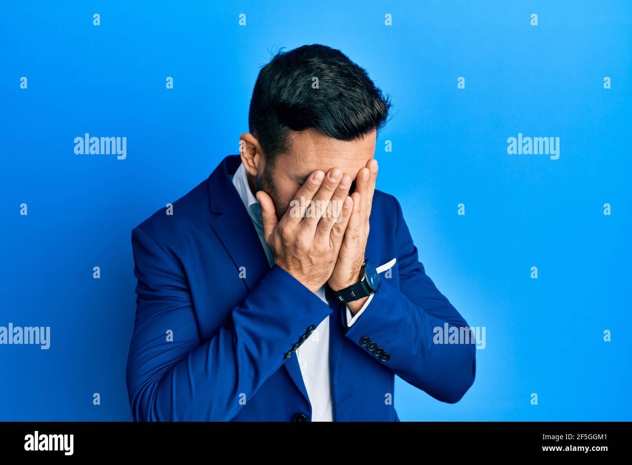 Young hispanic businessman wearing business jacket with sad expression ...